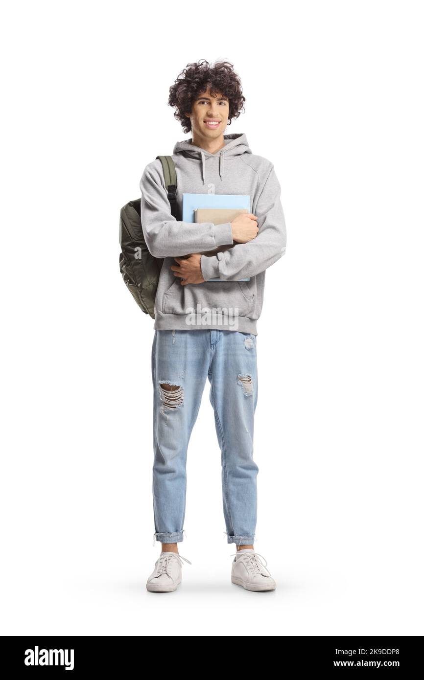 Full length portrait of a male student with curly hair carrying a ...