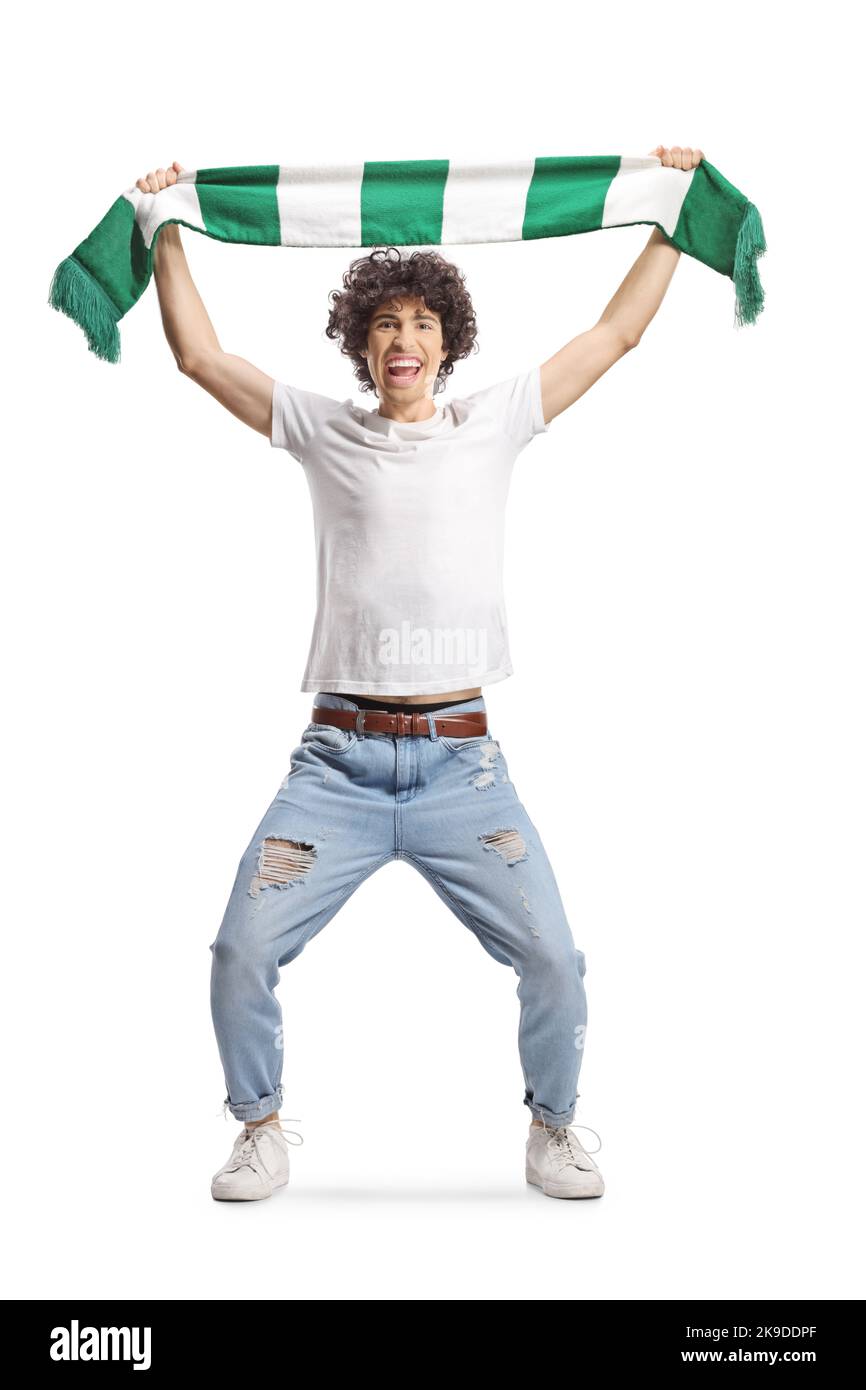Happy young man cheering with a green and white scarf isolated on white ...
