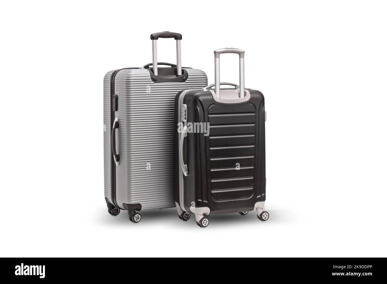 Big silver and smaller black hard side suitcases isolated on white ...
