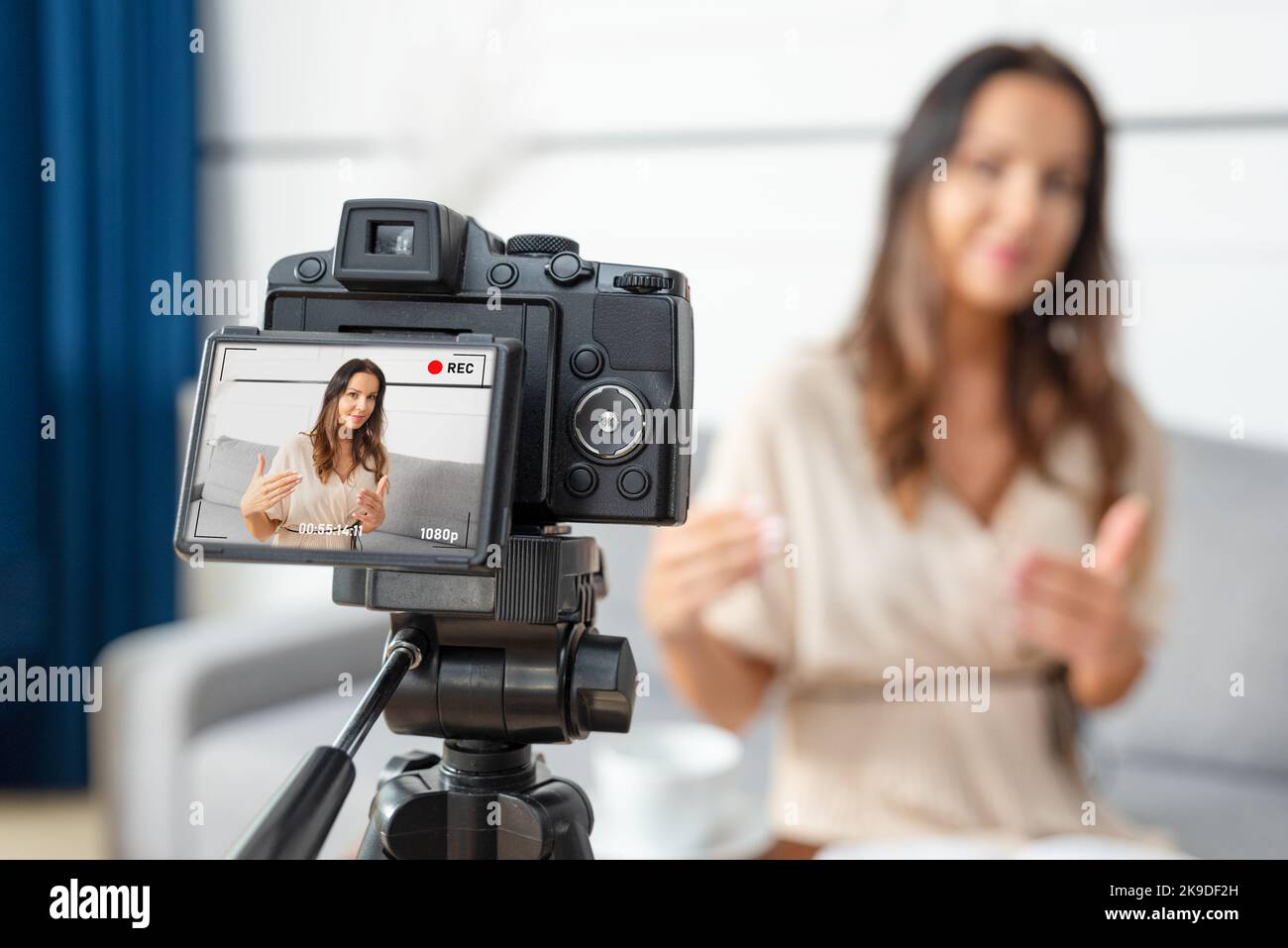 Young, beautiful woman broadcasting fashion tutorial. Internet content ...