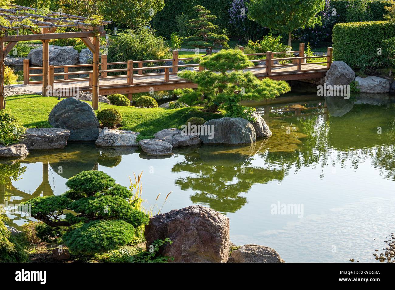 An idyllic pond with a stone path in the Japanese garden of the Mriya ...