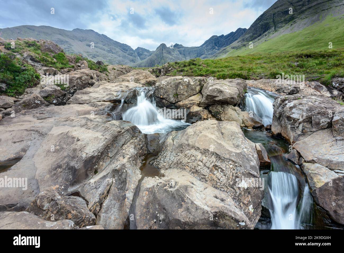 Long line of waterfalls and rocky mountain pools at the foot of the ...