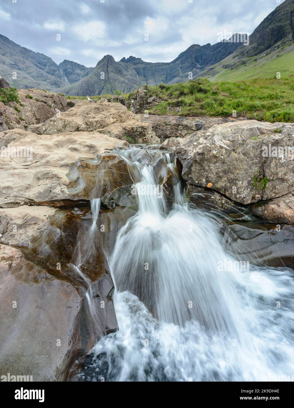Long line of waterfalls and rocky mountain pools at the foot of the ...
