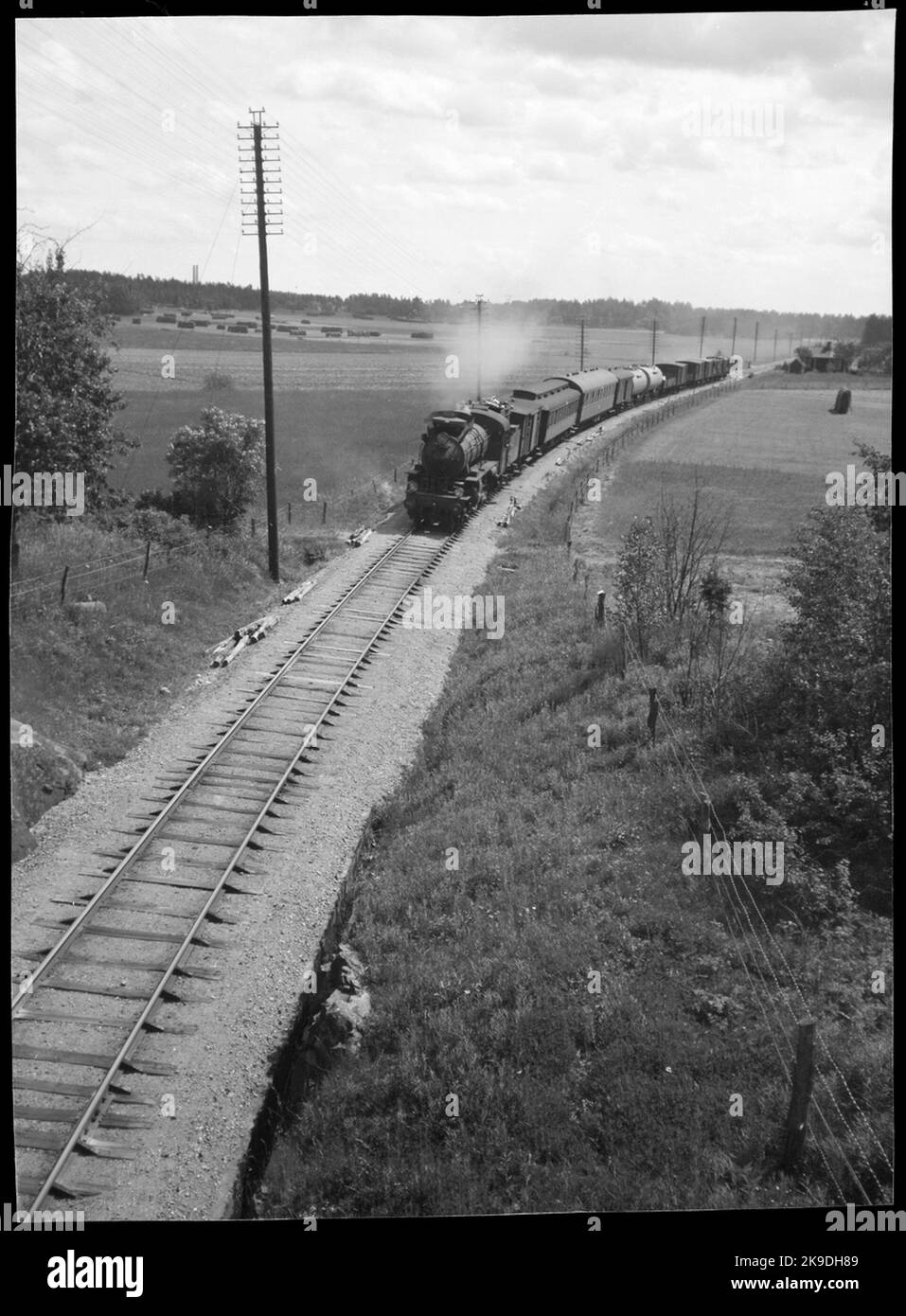 Mixed train drawn by wood -fired steam locomotive somewhere on ...