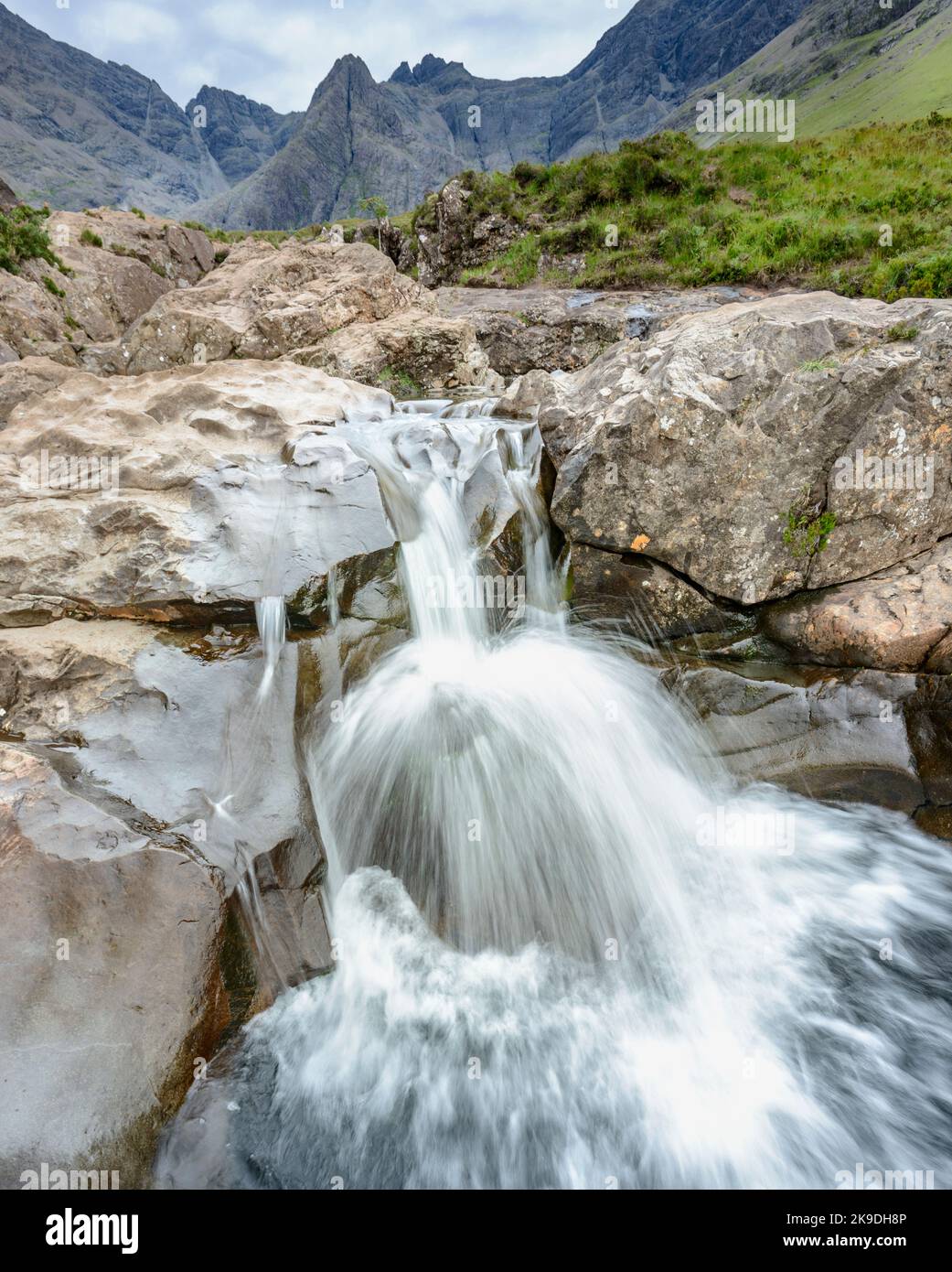 Long line of waterfalls and rocky mountain pools at the foot of the ...