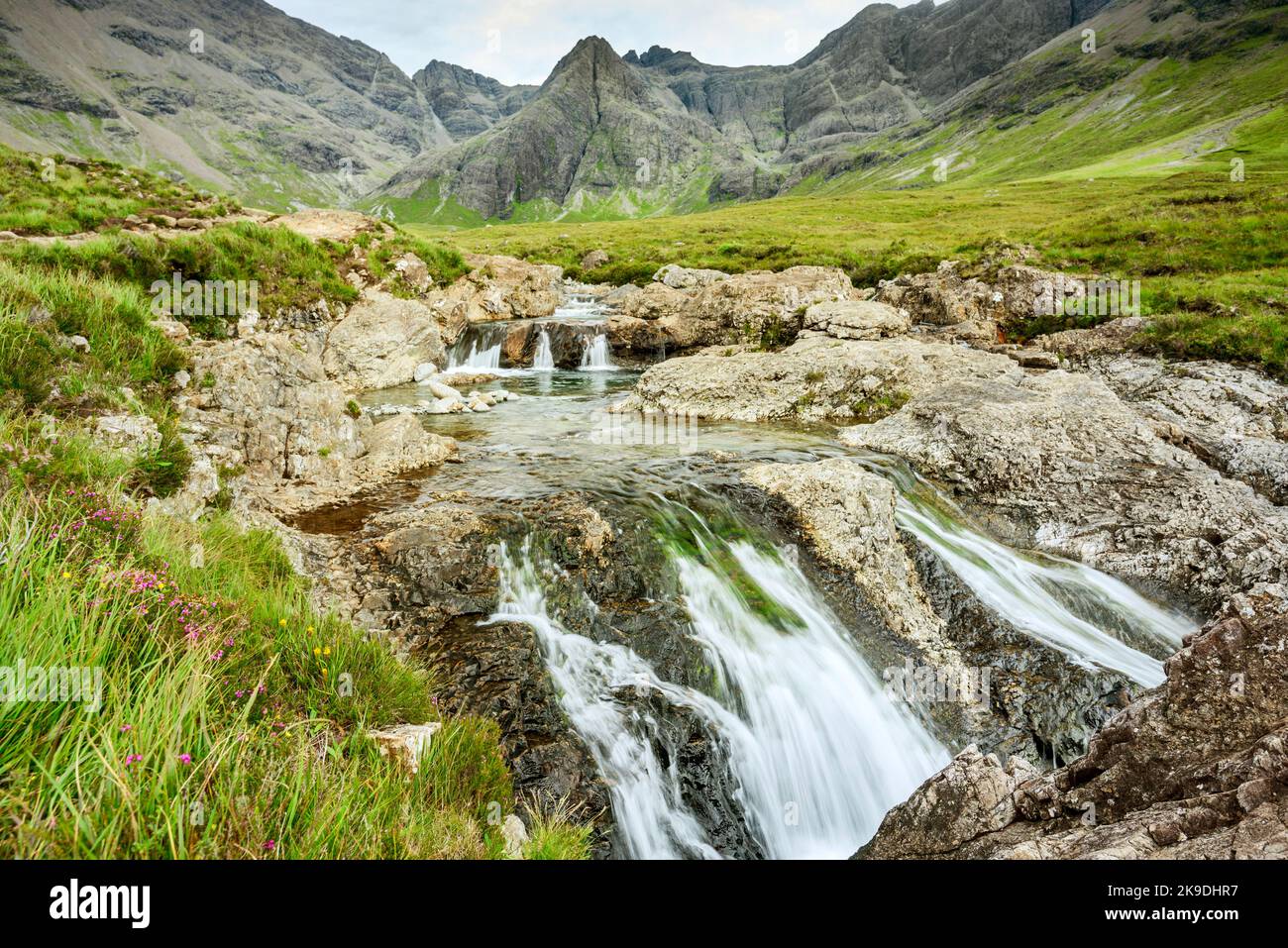 Long line of waterfalls and rocky mountain pools at the foot of the ...