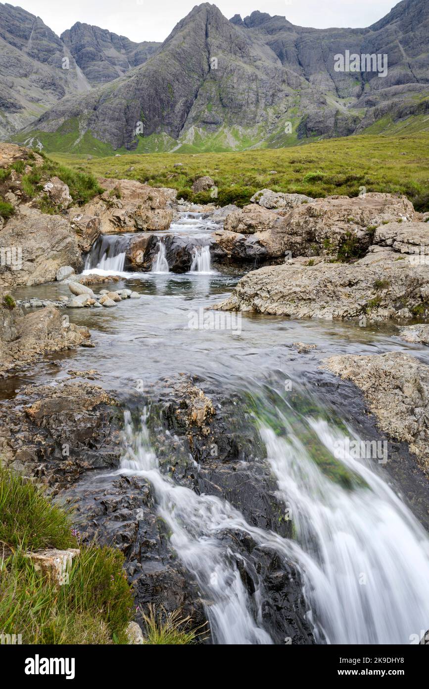 Long line of waterfalls and rocky mountain pools at the foot of the ...