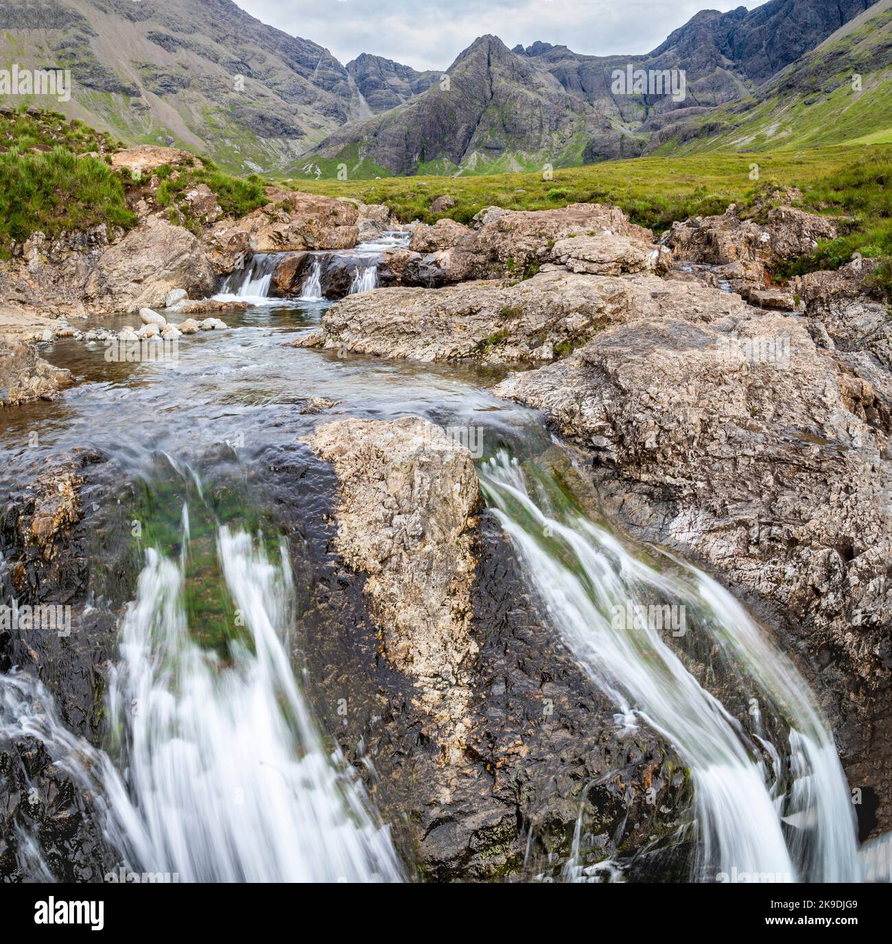 Long line of waterfalls and rocky mountain pools at the foot of the ...