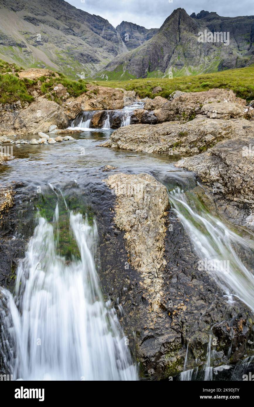 Long line of waterfalls and rocky mountain pools at the foot of the ...