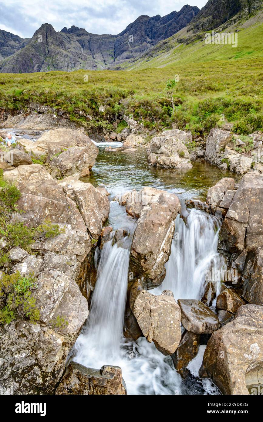 Long line of waterfalls and rocky mountain pools at the foot of the ...