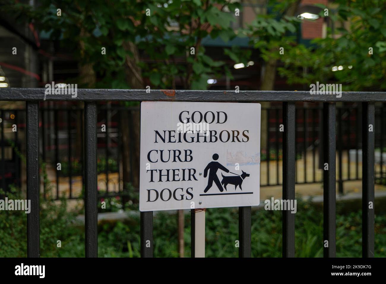 sidewalk urban street sign Good Neighbors Curb Their Dogs Stock Photo ...