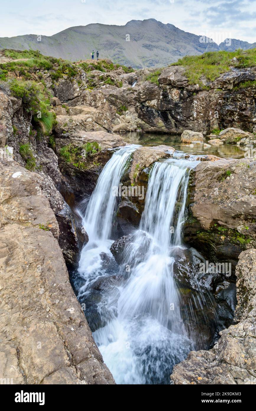 Long line of waterfalls and rocky mountain pools at the foot of the ...