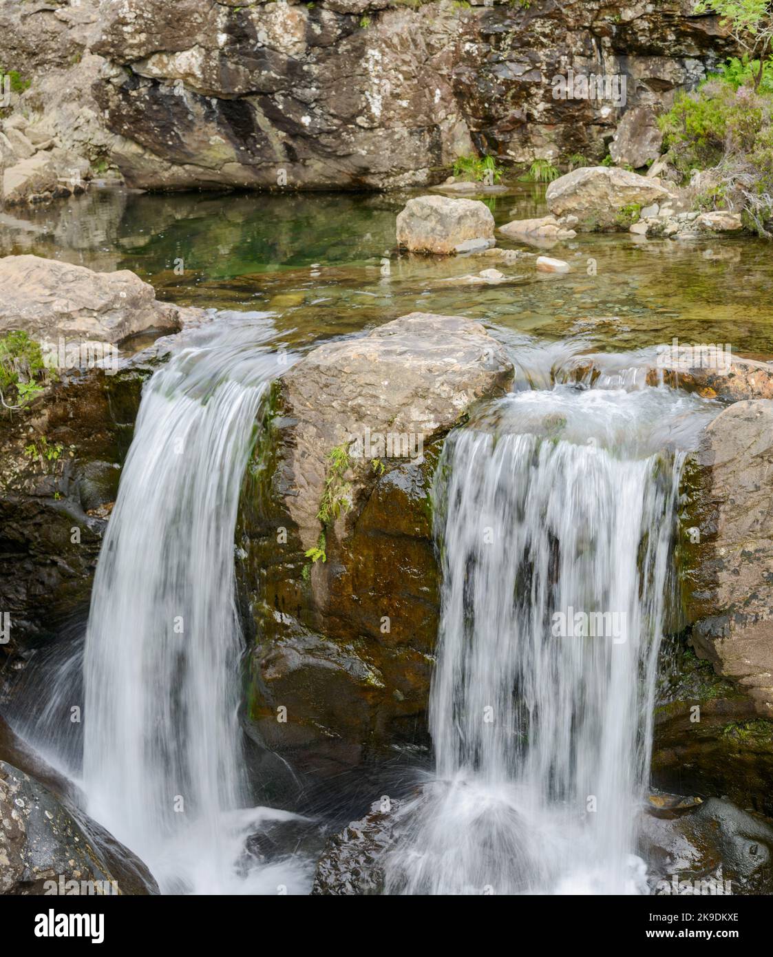 Long line of waterfalls and rocky mountain pools at the foot of the ...