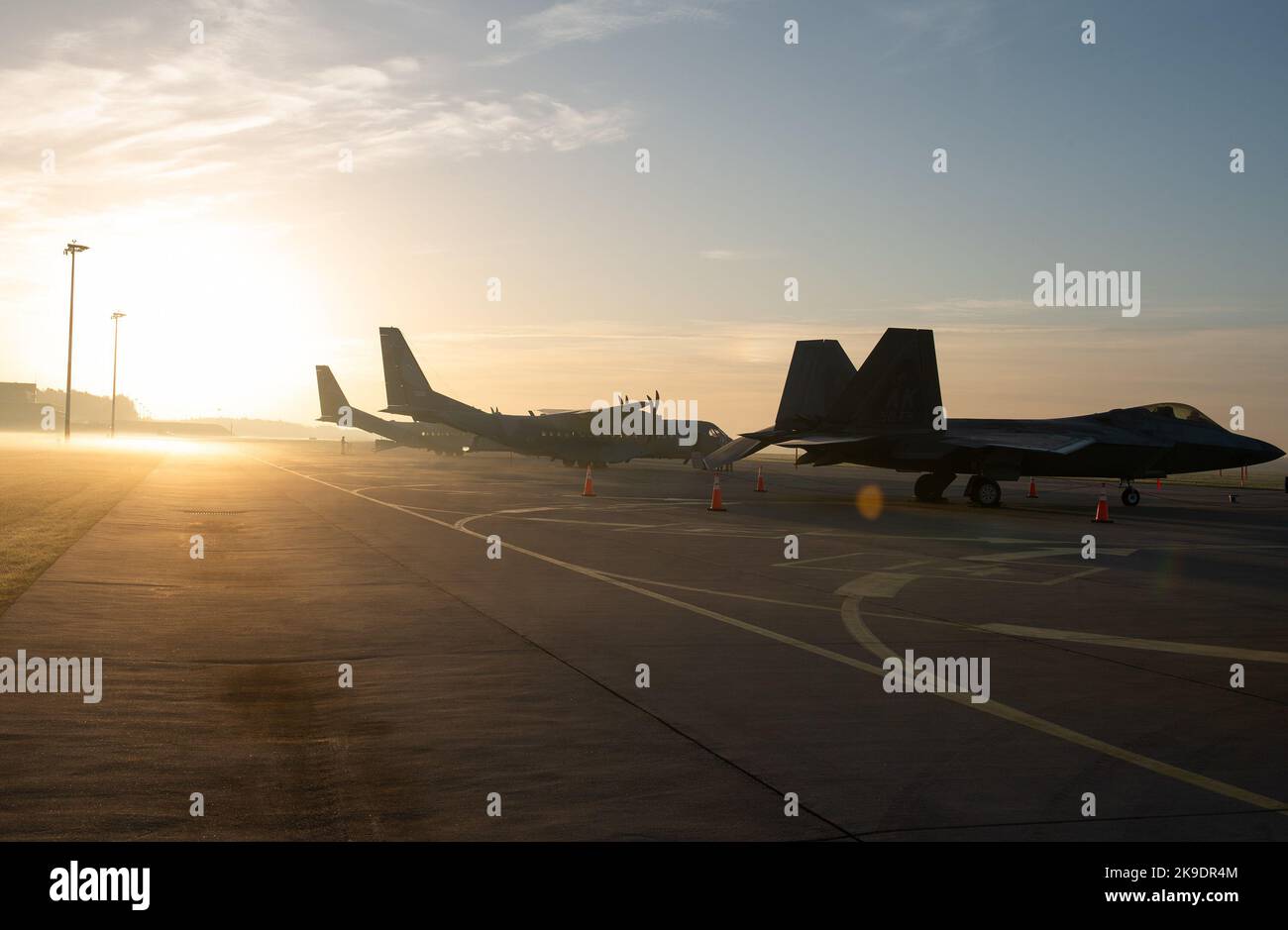 Polish Air Force CASA 295s sit on the flight line next to an F-22 ...
