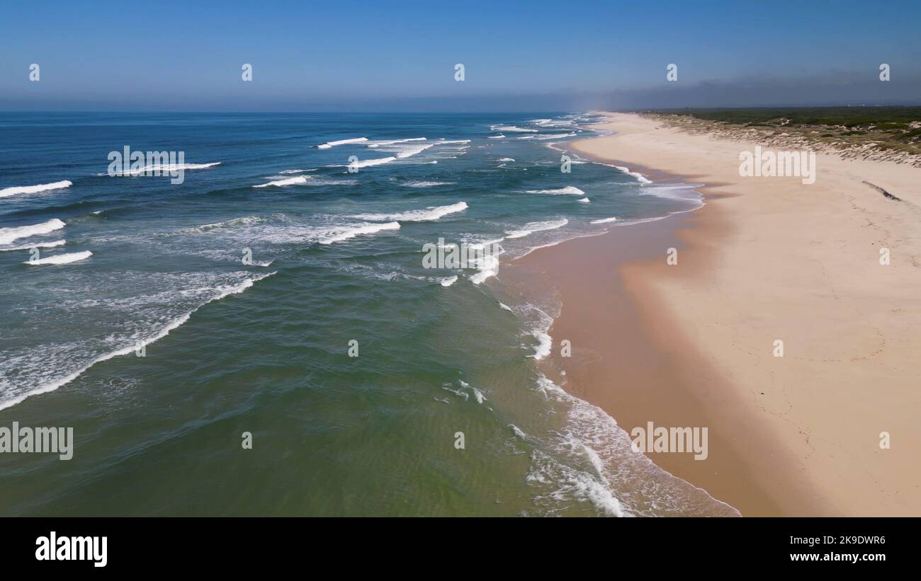 Side view of waves crashing on sandy beach aerial - a bird's eye view ...