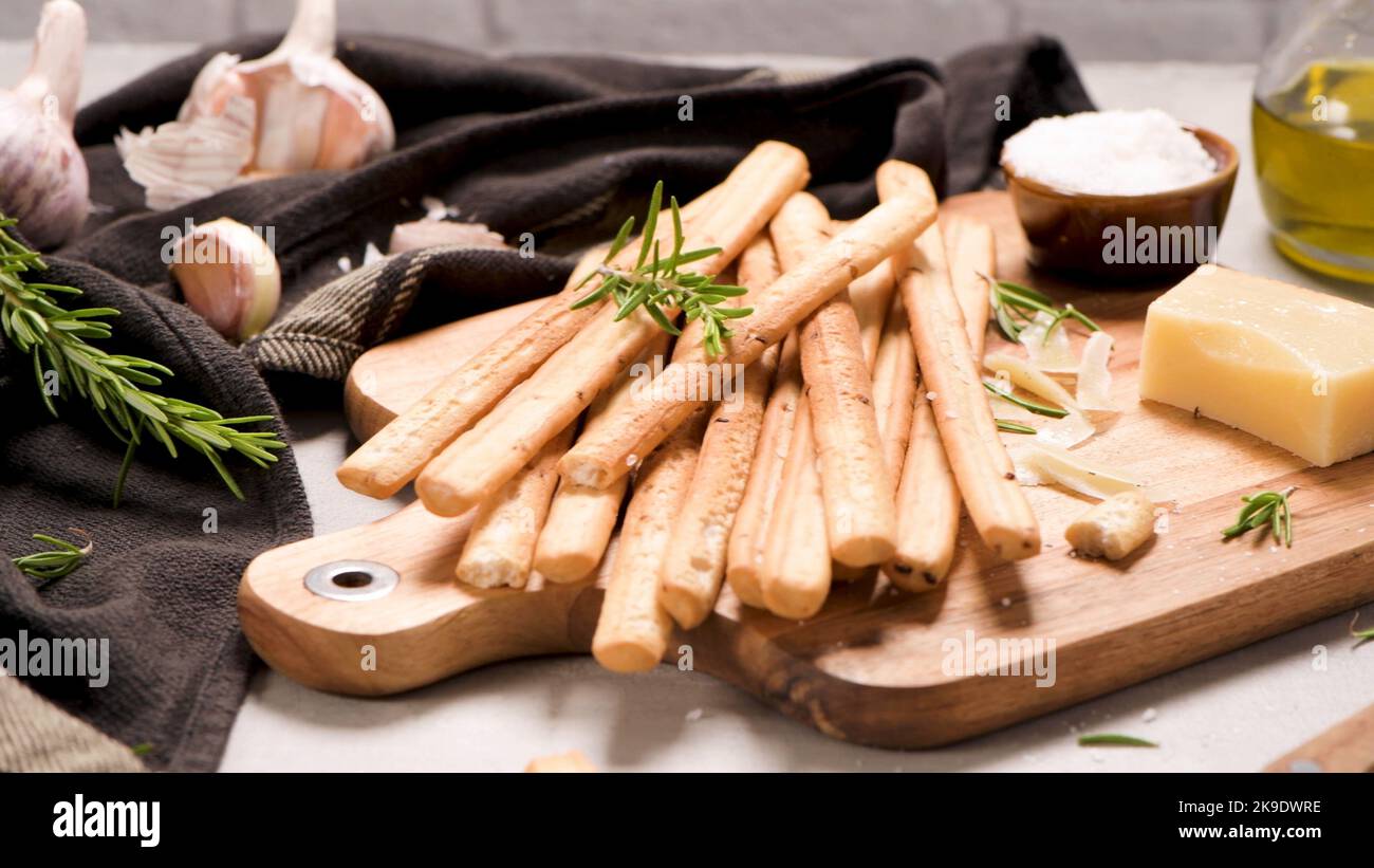 Fresh baked homemade grissini bread sticks in vintage metal grid box ...