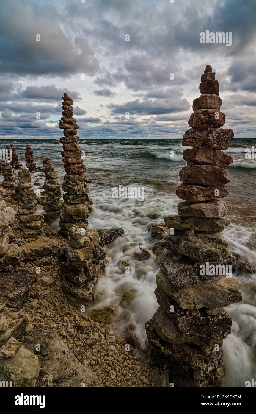 Stacked rocks or cairns populate the Cave Point County Park Lake ...