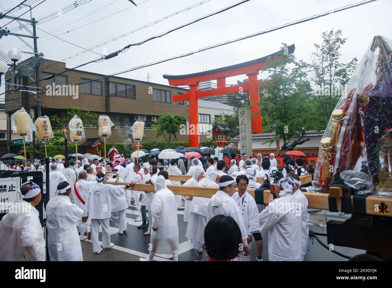 Crowd of people wearing white costume gather in street at front of ...