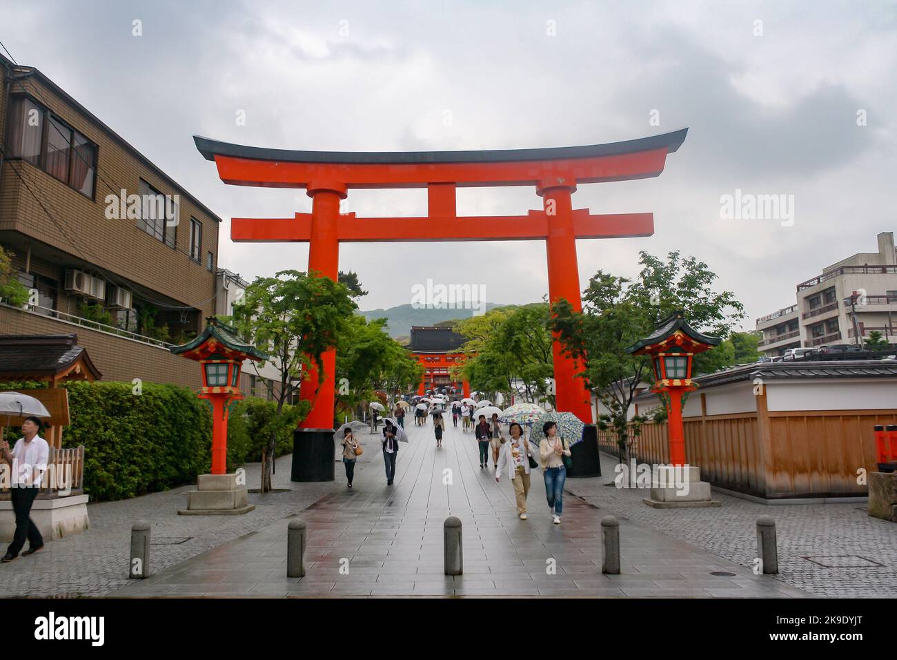 Front entrance of Fushimi Inari Shrine with large red torii gate and ...