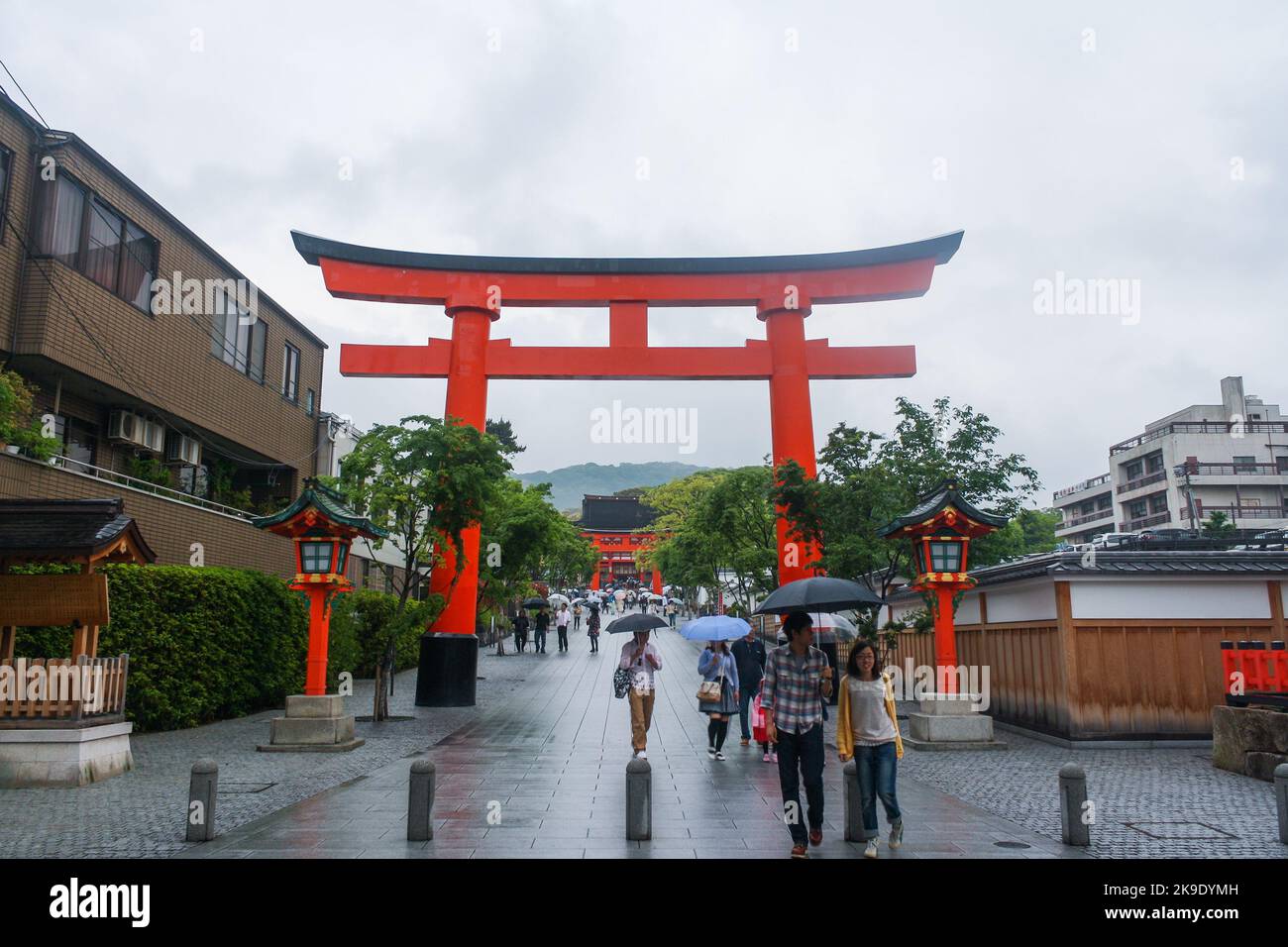Front entrance of Fushimi Inari Shrine with large red torii gate and ...