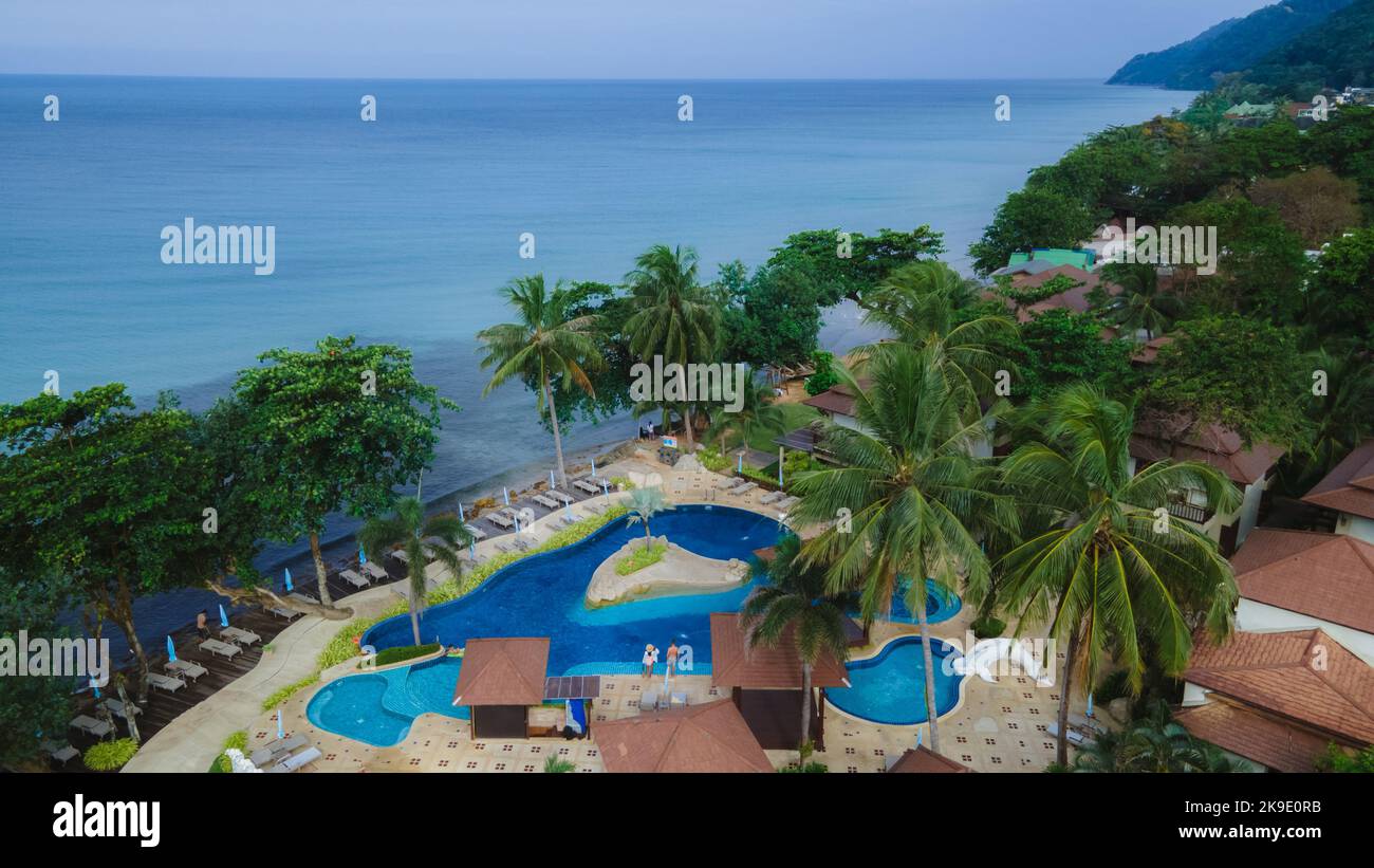 Drone aerial view of a luxury hotel pool from above. A couple of men ...