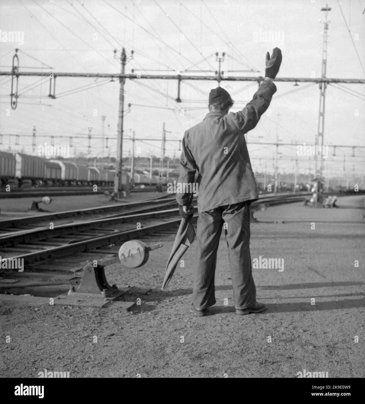 Railway official gives signal Stock Photo - Alamy