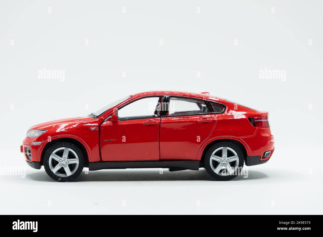 Red SUV toy car on white background Stock Photo - Alamy