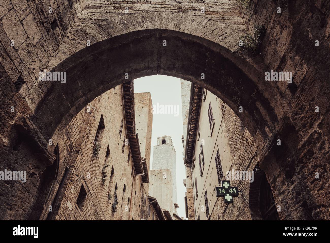 View of a stone arch on an alley of a medieval town Stock Photo - Alamy