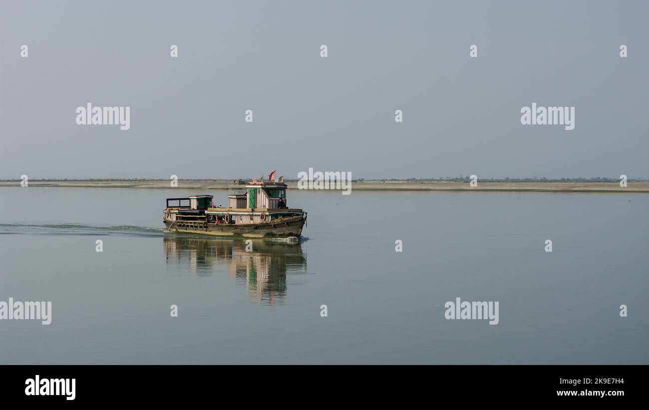 Scenic landscape view of small wooden ferry boat crossing the mighty ...