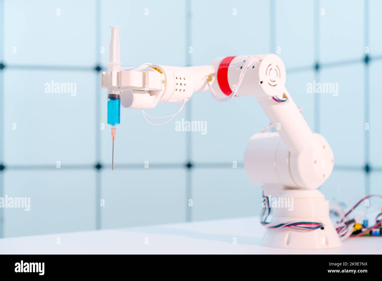 Robot hand with a medical syringe. Future medicine concept using robots ...