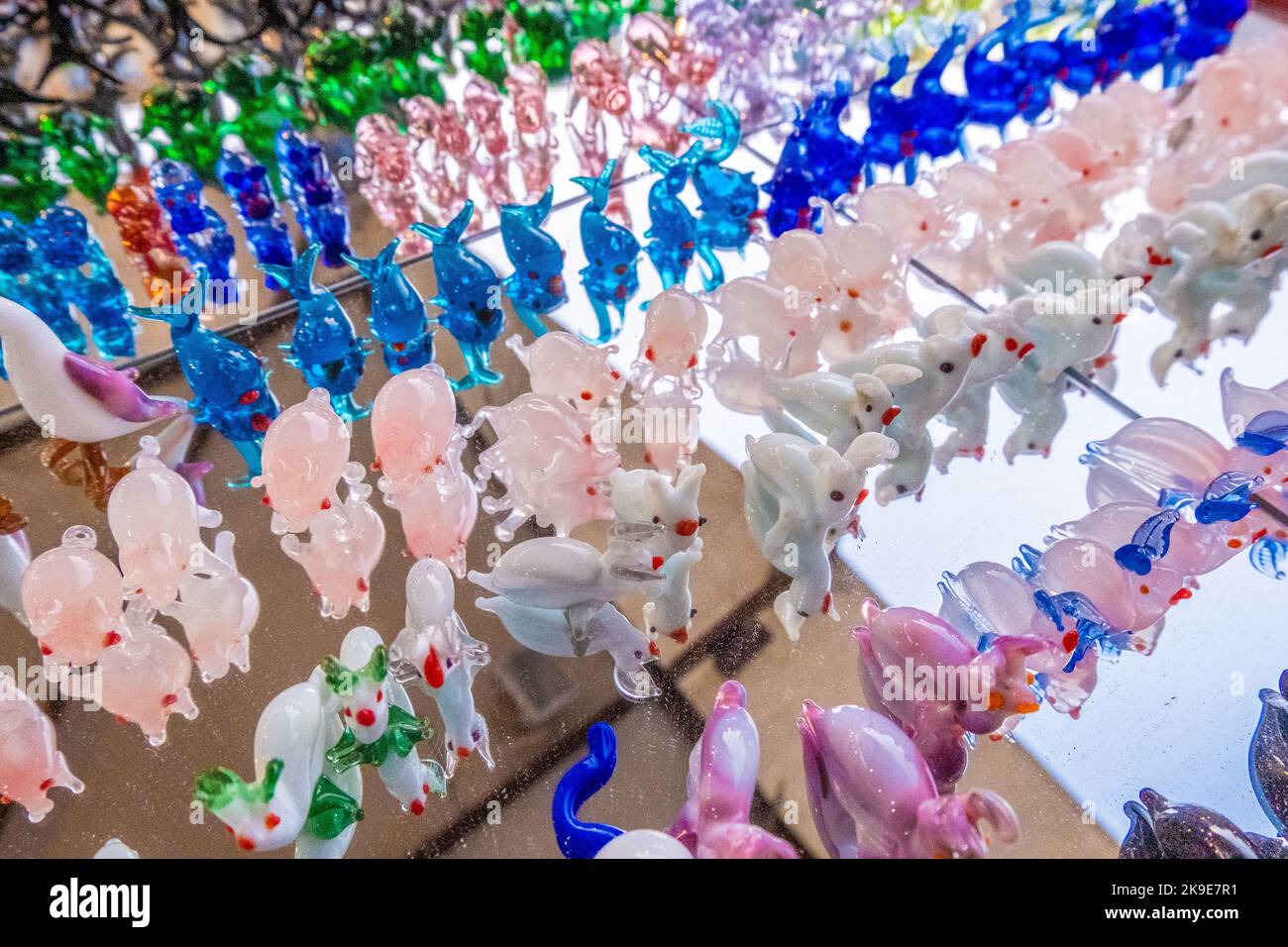 Colorful animals made from murano glass on a mirror Stock Photo - Alamy
