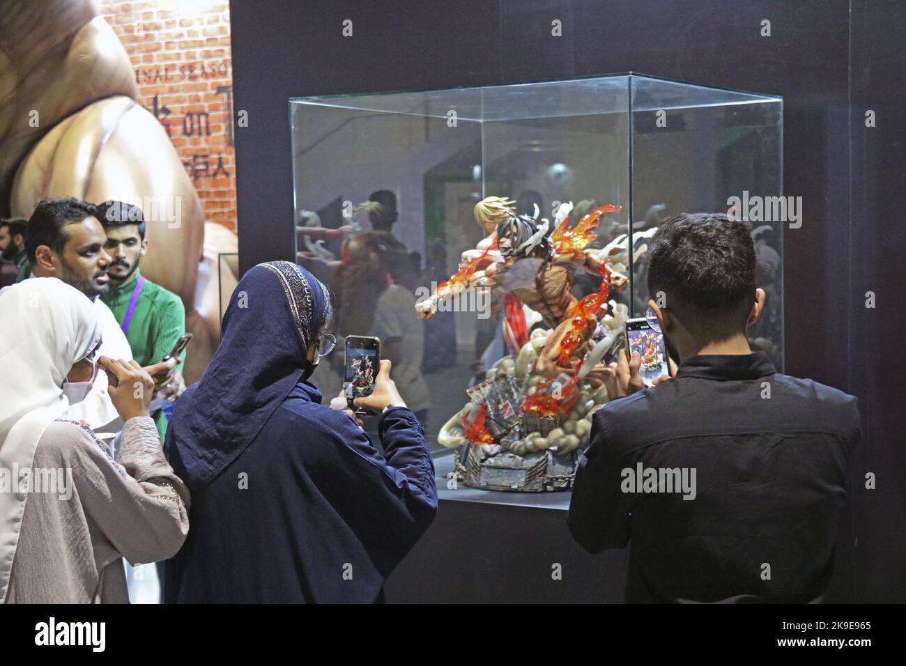 Visitors take photos of an anime figure on display at the Saudi Anime ...
