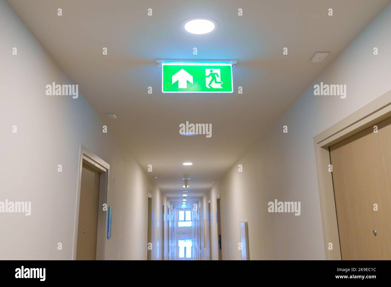 Fire Emergency exit sign on the wall background inside building. Safety ...