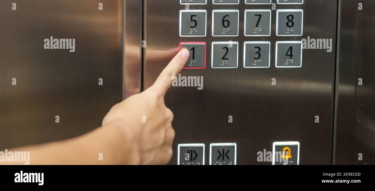 Hand finger press the Elevator button, woman using Elevator in office ...