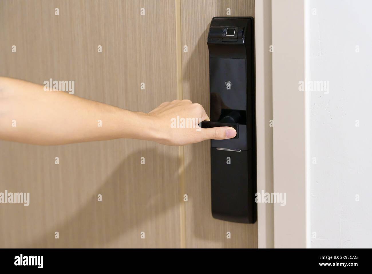 man holding handle of smart digital door lock while open or close the ...