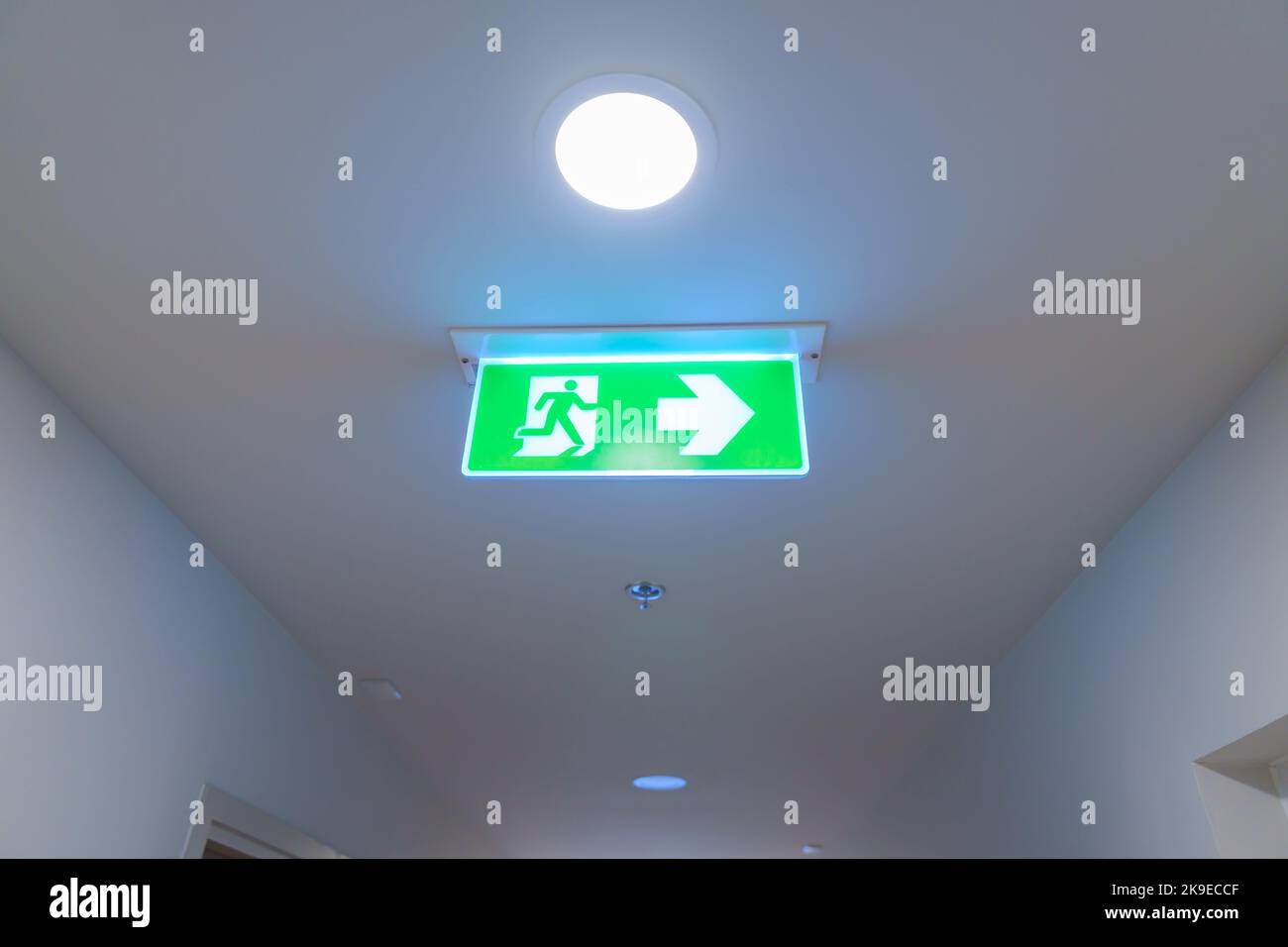 Fire Emergency exit sign on the wall background inside building. Safety ...