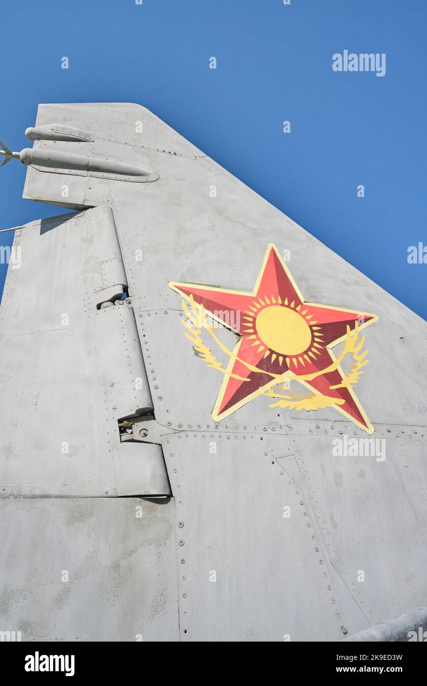 Detail of a red star on the tail of a MIG-29 fighter jet parked next to ...