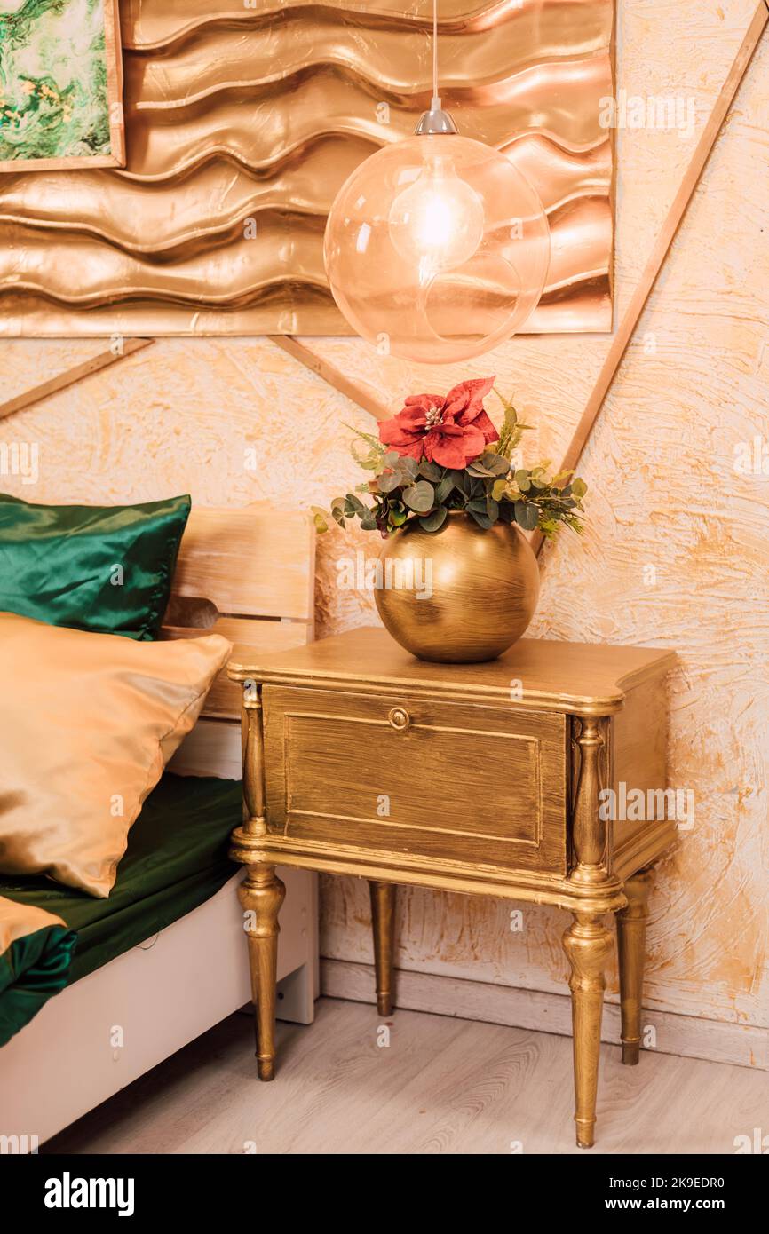 Bedside table of gold color in the bedroom. Home interior Stock Photo ...