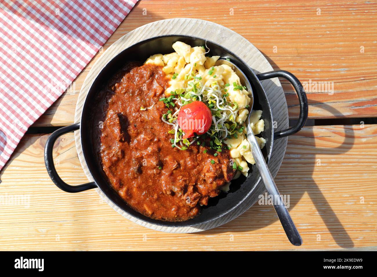 Goulash with spaetzle in a pan Stock Photo - Alamy