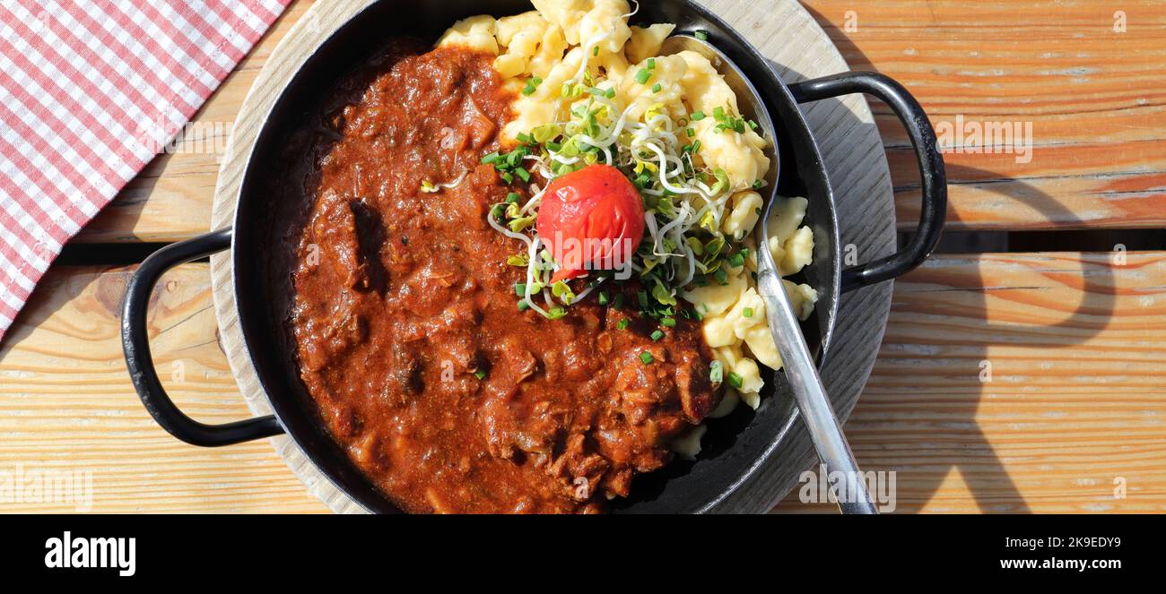 Goulash with spaetzle in a pan Stock Photo - Alamy