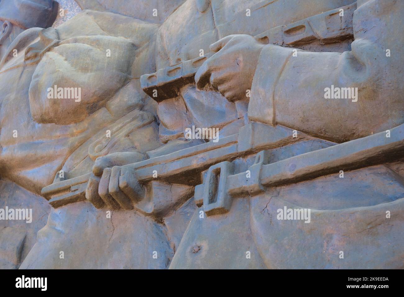 A detailed view on a bronze frieze of a machine gun barrel, being used ...