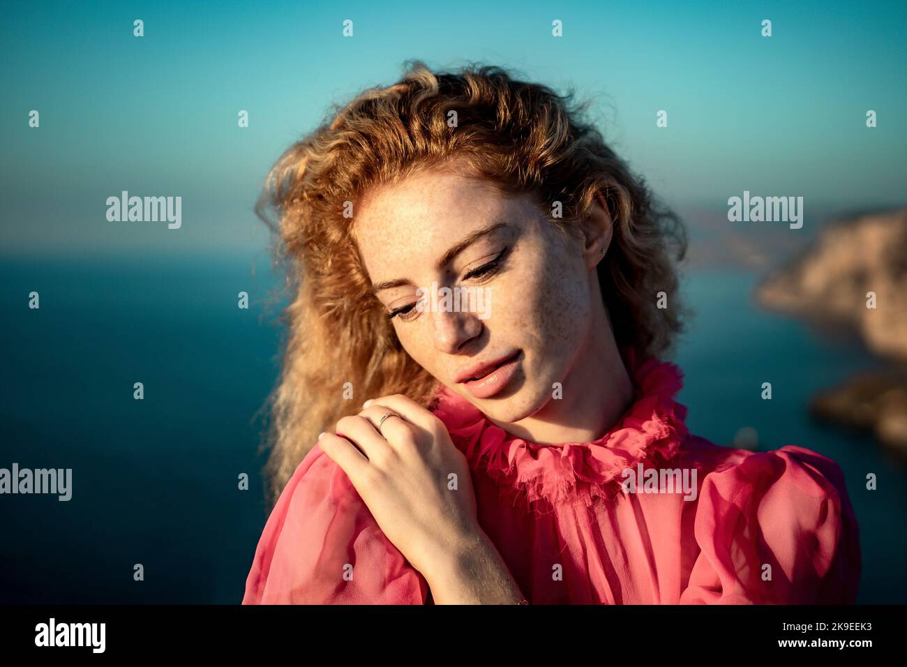 Close up portrait of curly redhead young caucasian woman with freckles ...
