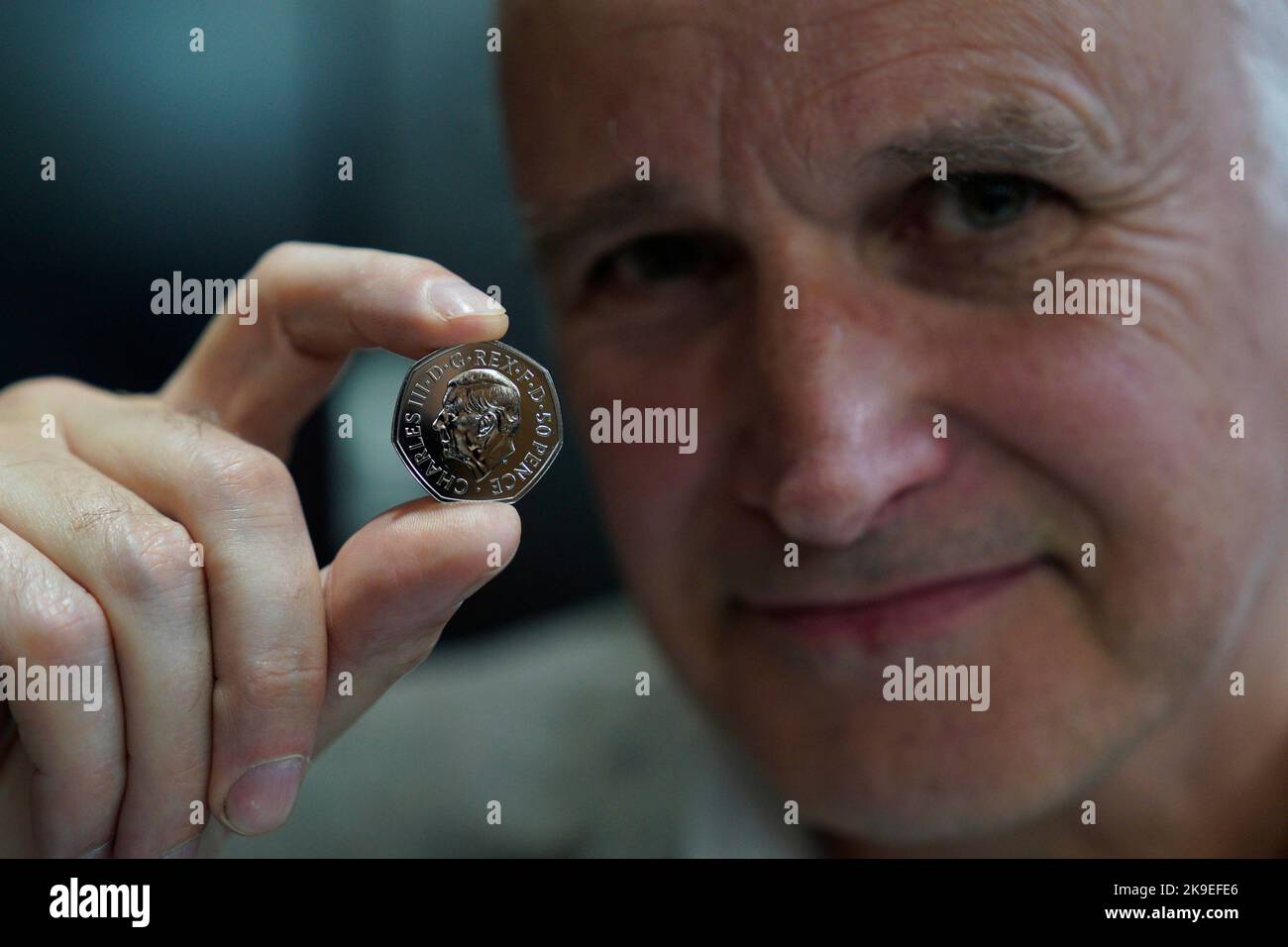 EDITORIAL USE ONLY Artist Martin Jennings with one of the first coins ...