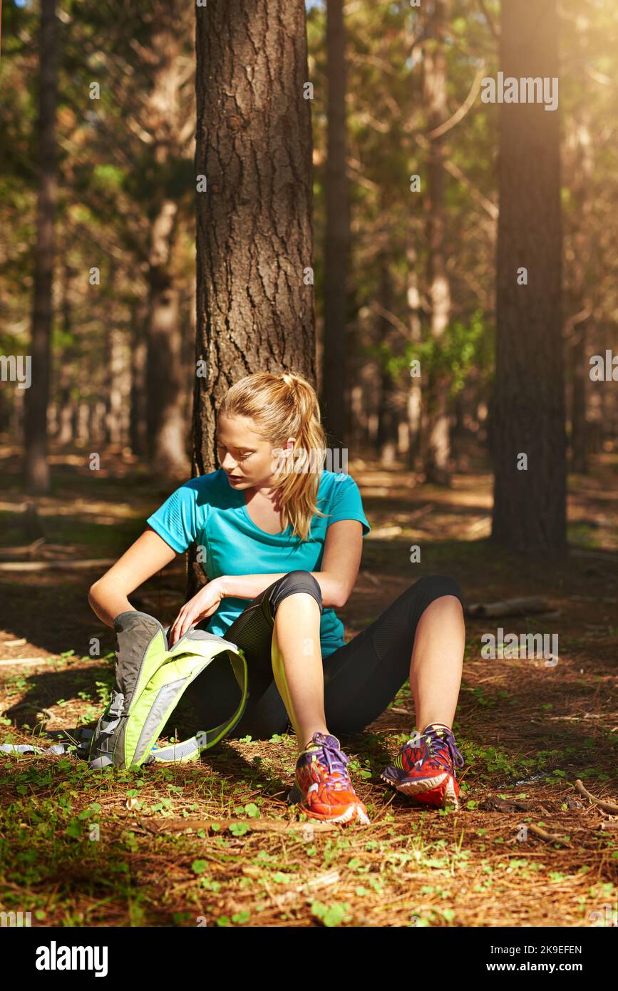 Time for a short break. a young woman out in nature to exercise Stock ...
