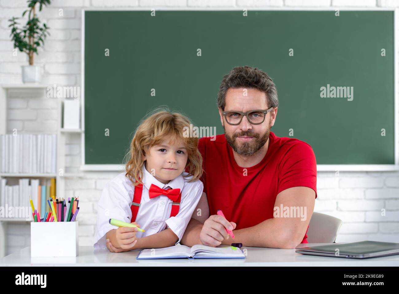 First day at school. Cute little boy studying lesson in class. Cute ...