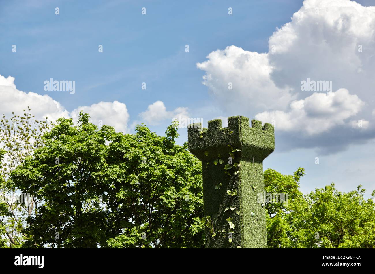 In the shape of a castle tower topiary green trees hedge in ornamental ...