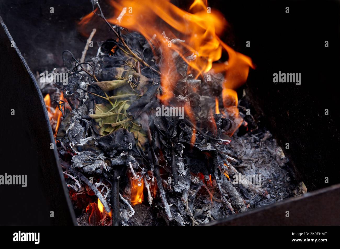 Burning red hot sparks fly from fire. Barbecue gril with glowing and ...