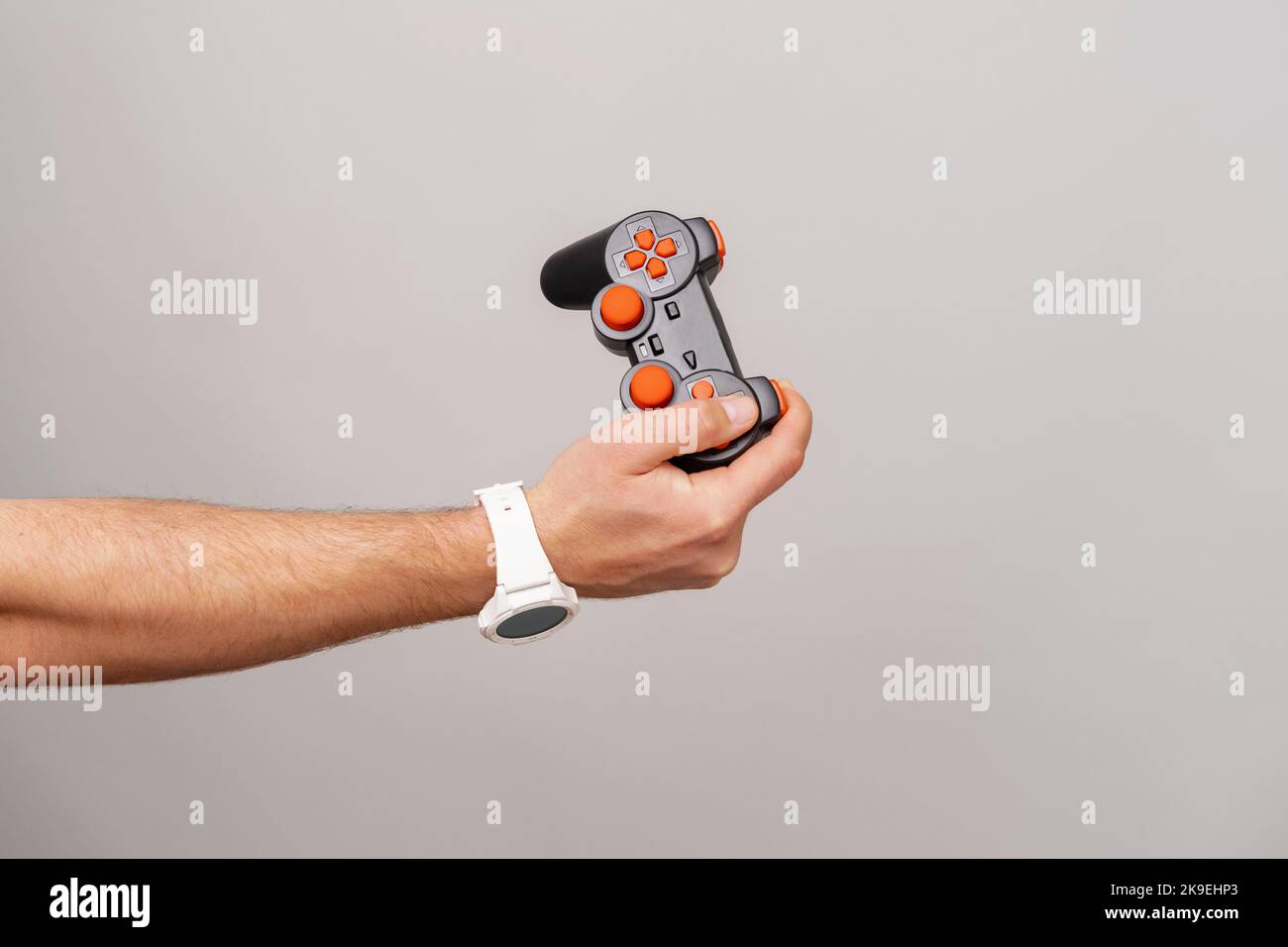 Photo of male hand holding joystick over grey background Stock Photo ...