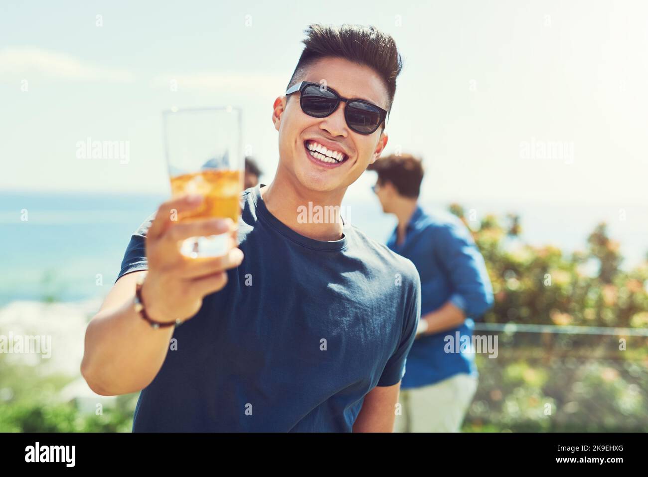 Come and join the party. Portrait of a handsome young man raising up ...