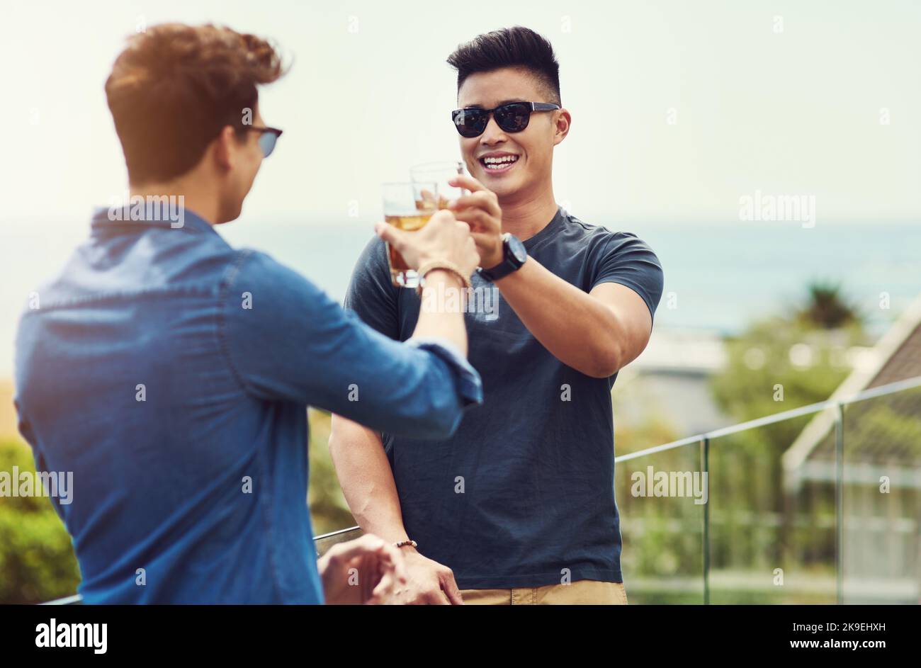 This moment deserves a toast. two handsome young men having drinks and ...